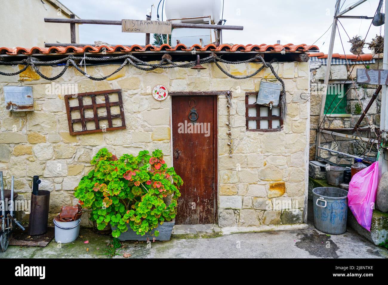 A small idyllic romantic limestone hut with a clay tile roof in a ...
