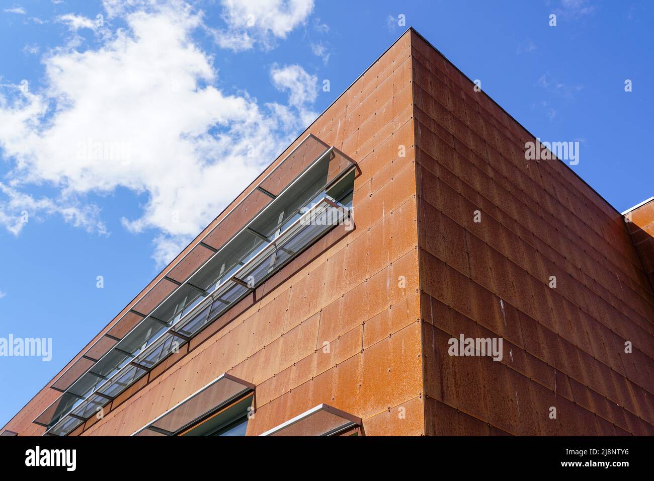 Rusted corten steel panels cladding facade of a modern design house on ...