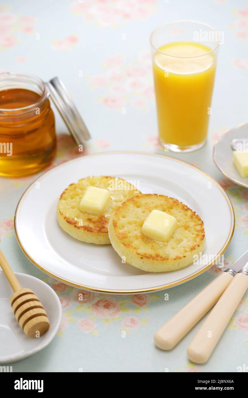 toasted homemade crumpets with butter, english breakfast Stock Photo ...