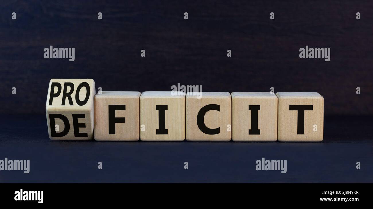 Proficit or deficit symbol. Turned wooden cubes and changed the concept word deficit to proficit ...