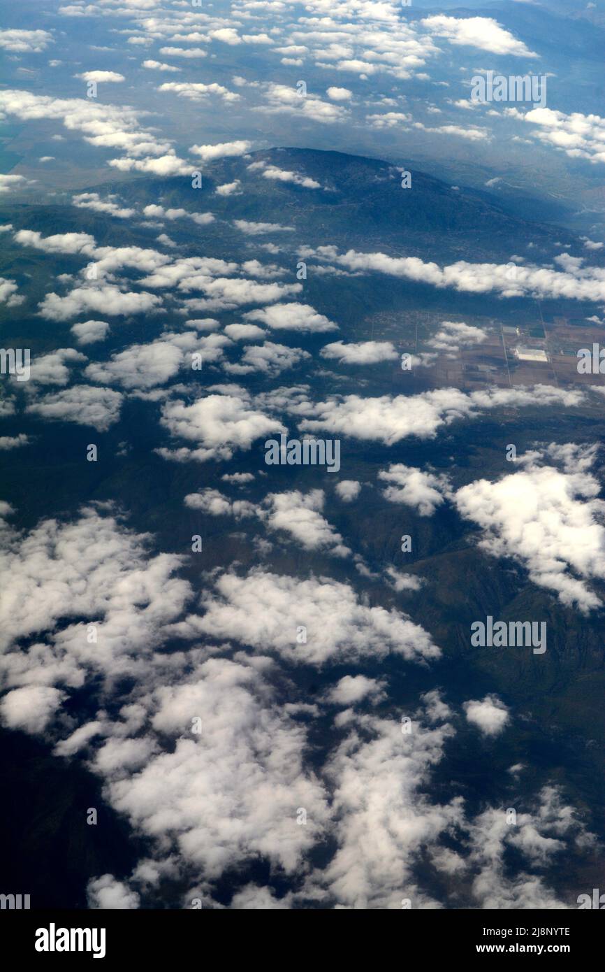 A view of clouds and irrigated fields as seen from a passenger aircraft ...