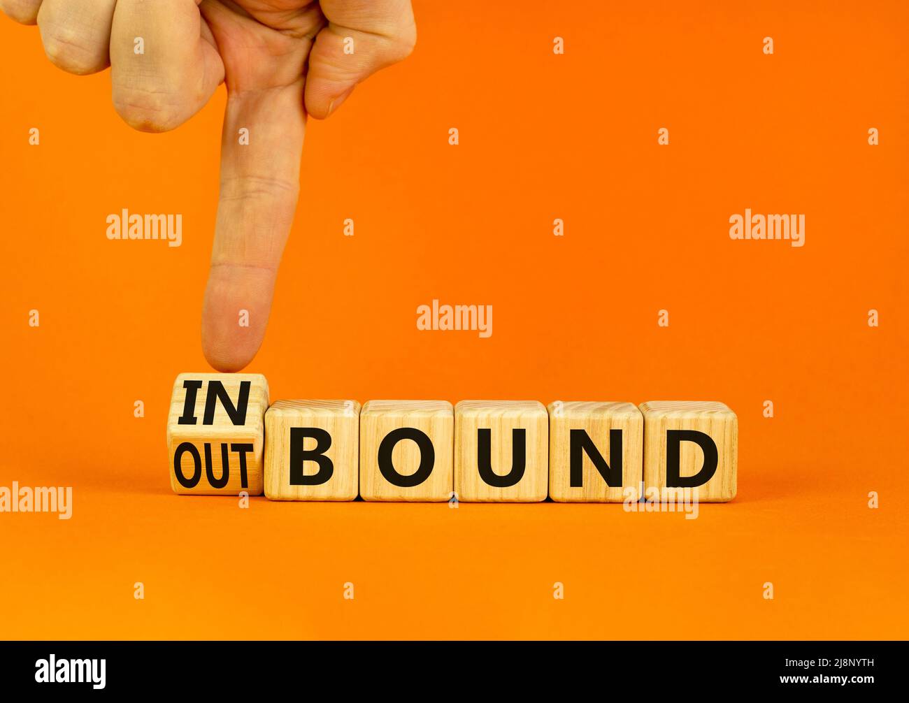 Inbound or outbound symbol. Businessman turns wooden cubes and changes ...