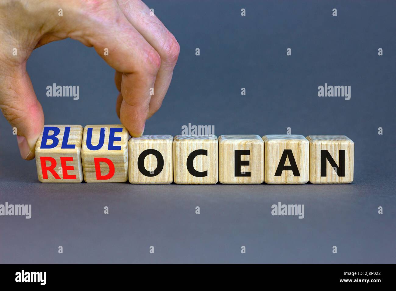 Blue or red ocean symbol. Businessman turns cubes and changes concept ...