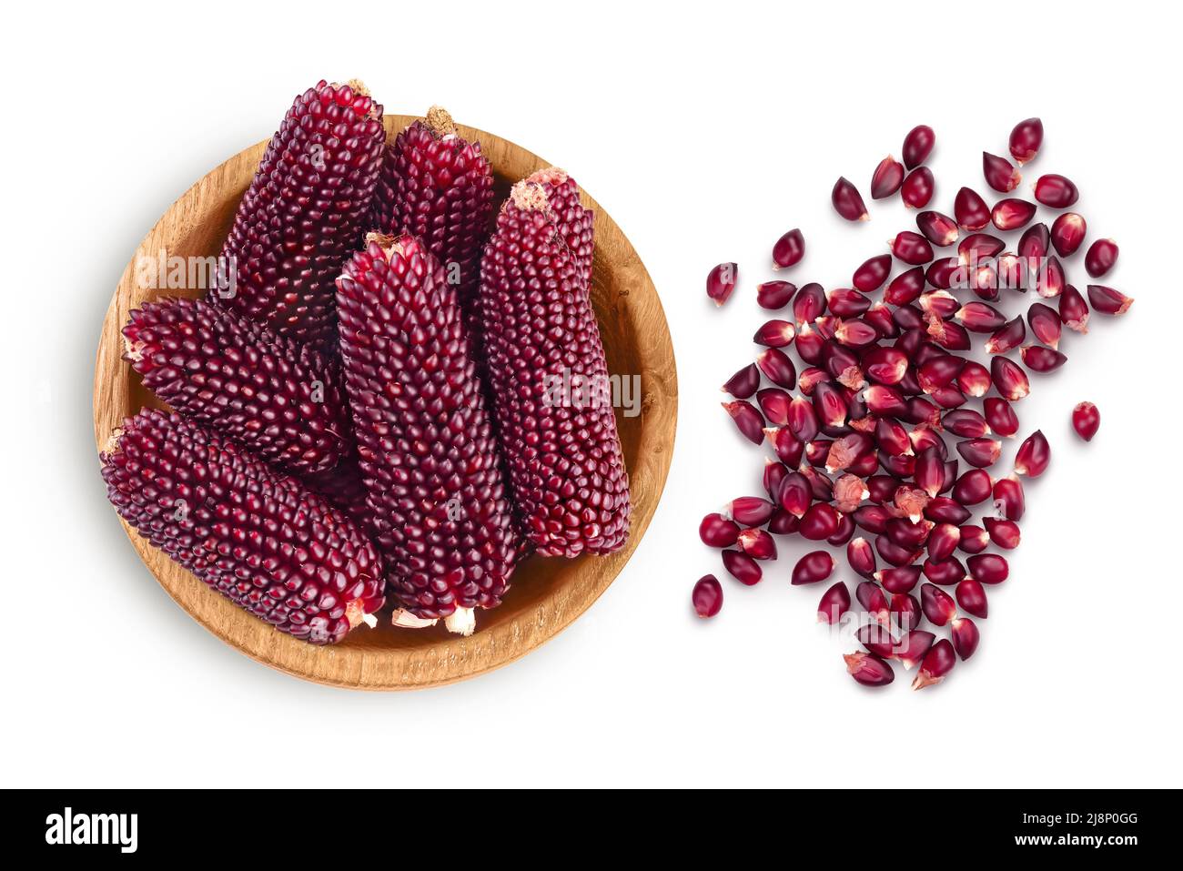 Purple corn or maize seeds in wooden bowl isolated on white background ...
