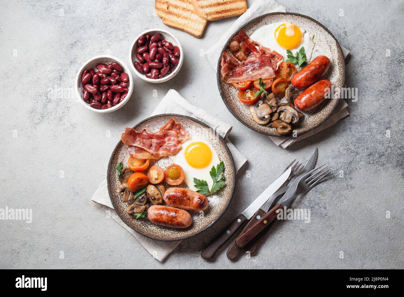 English breakfast on gray plates on white background Stock Photo - Alamy