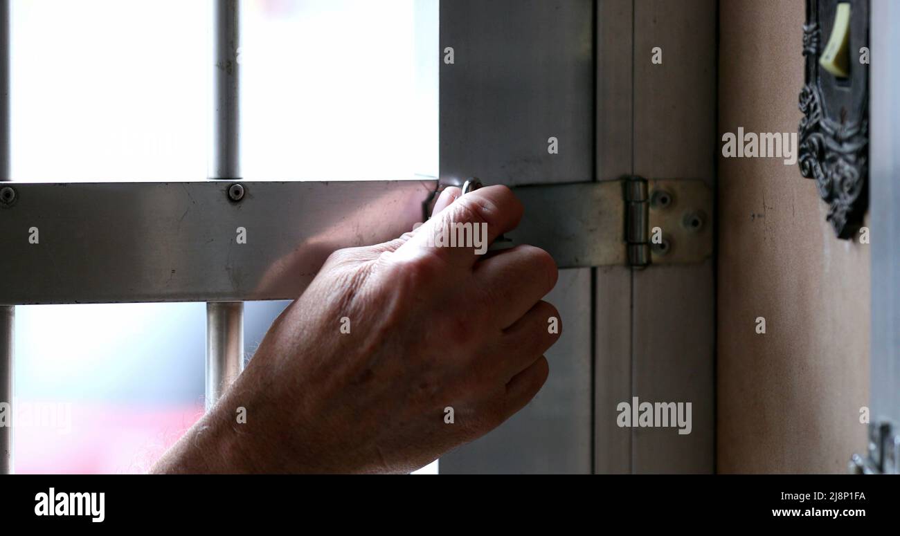 Person closing gate hi-res stock photography and images - Alamy