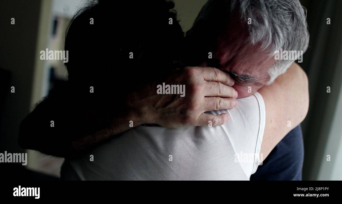 Senior man crying in wife shoulders Stock Photo - Alamy