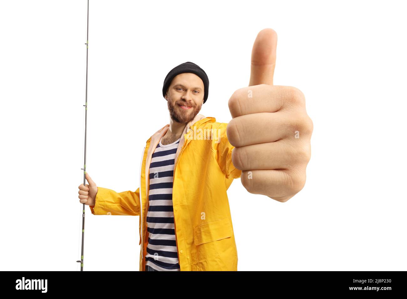 Smiling fisherman in a yellow raincoat holding a fishing rod and ...
