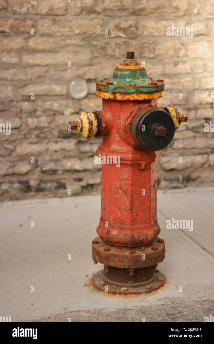 A vintage red metallic fire hydrant in the ground for fighting urban ...