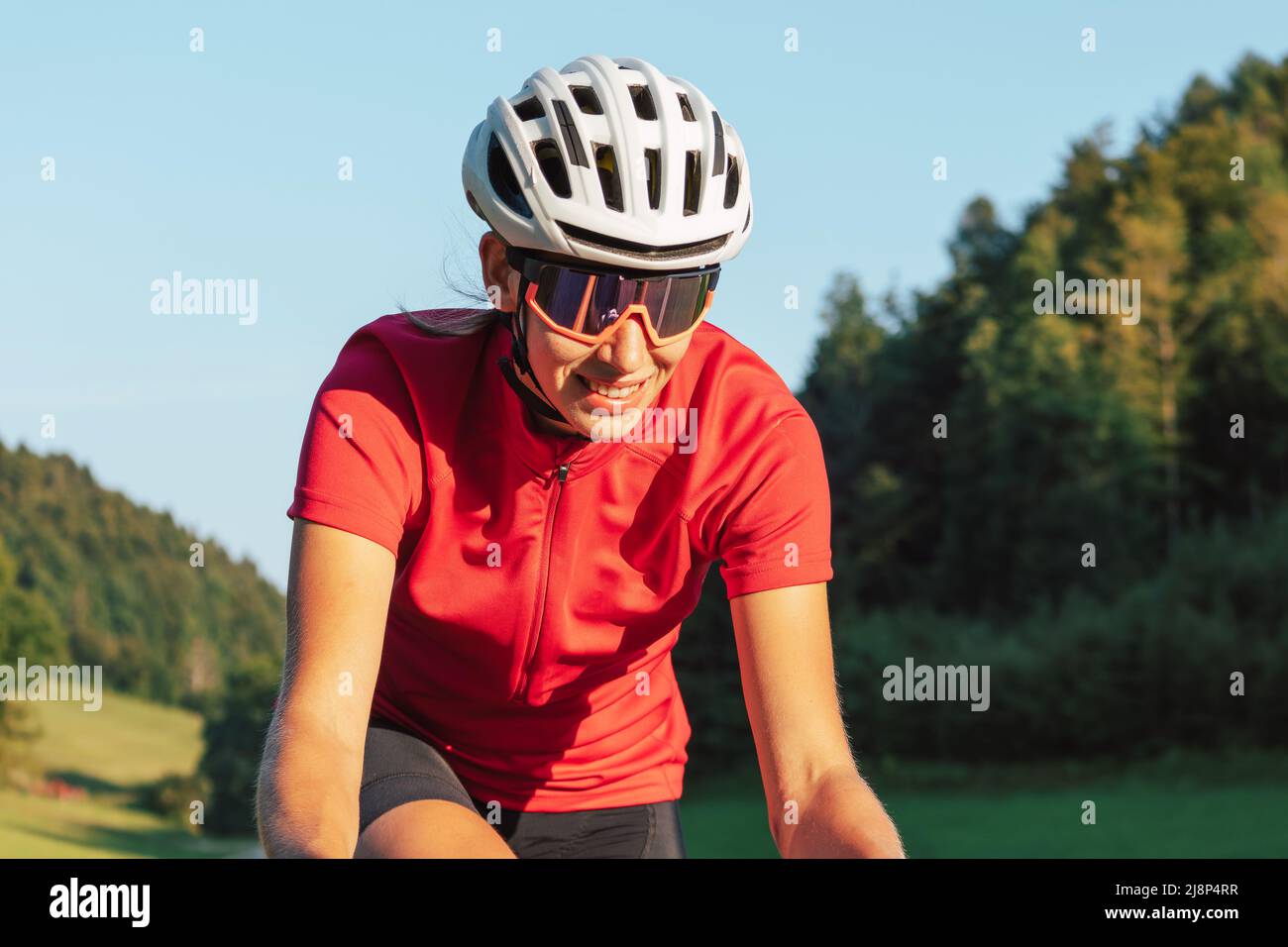 Caucasian girl cyclist with professional racing sports gear riding on ...