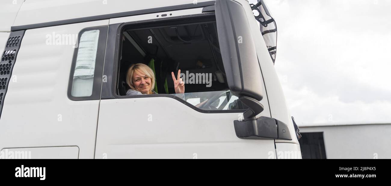 Caucasian mid age woman driving truck. trucker female worker, transport ...