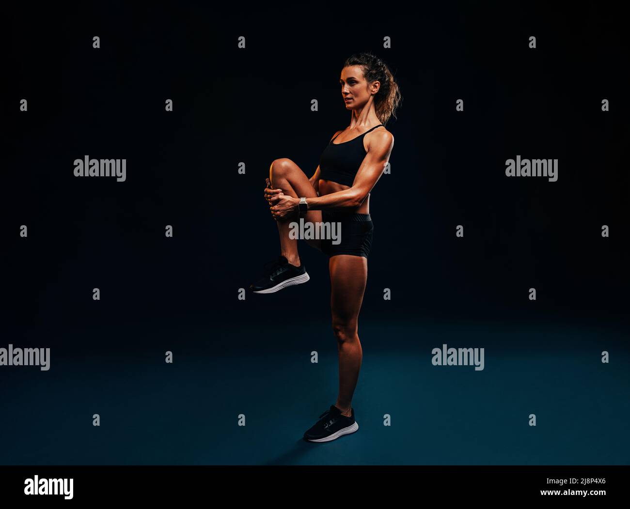 Sports woman doing flexibility exercises. Young female runner ...