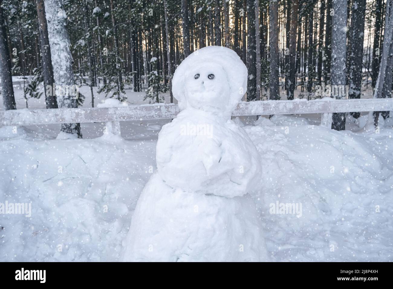 Snowmen in the park. Winter entertainment for children in snowy weather ...