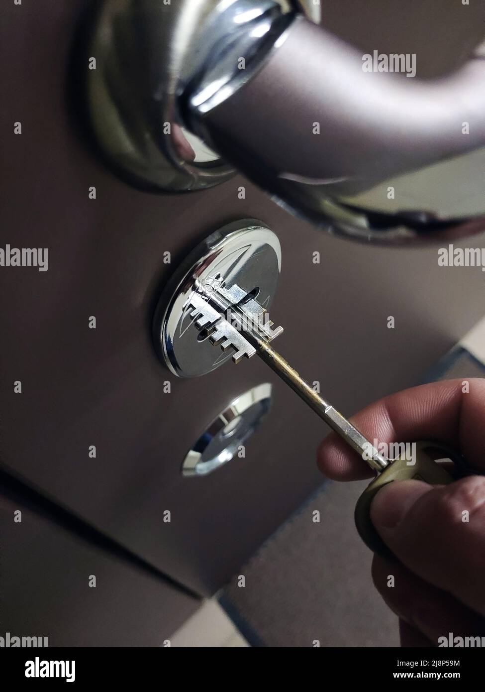 The hand opens the lock in the door with a key. Front and back ...