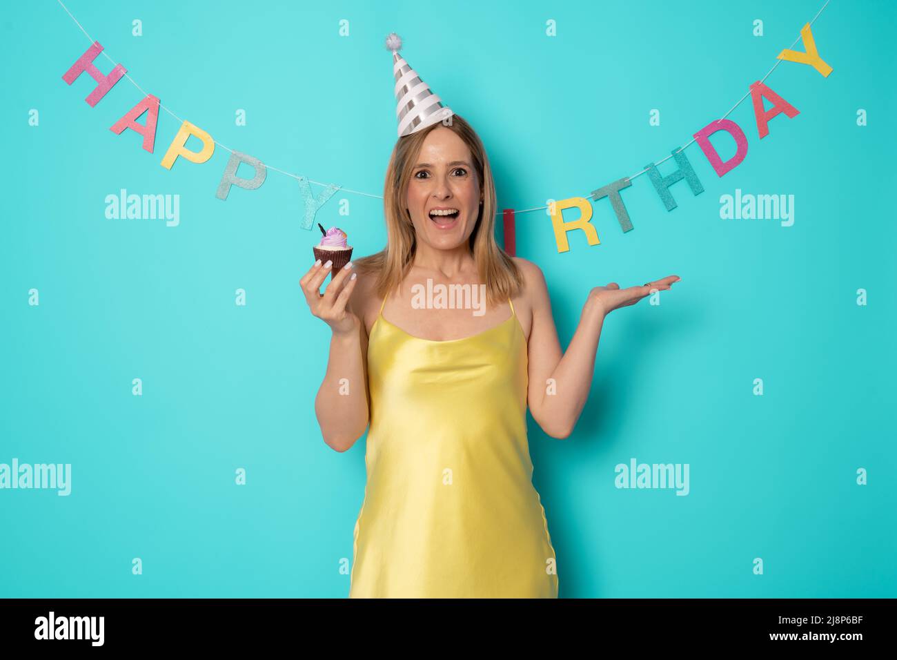 Amazed Woman Celebrating Her Birthday With Cake In Hands Wearing