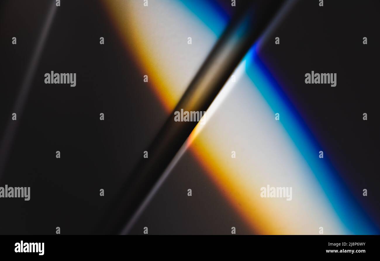 Beam of sunlight with spectrum colors goes over white wall, refraction ...