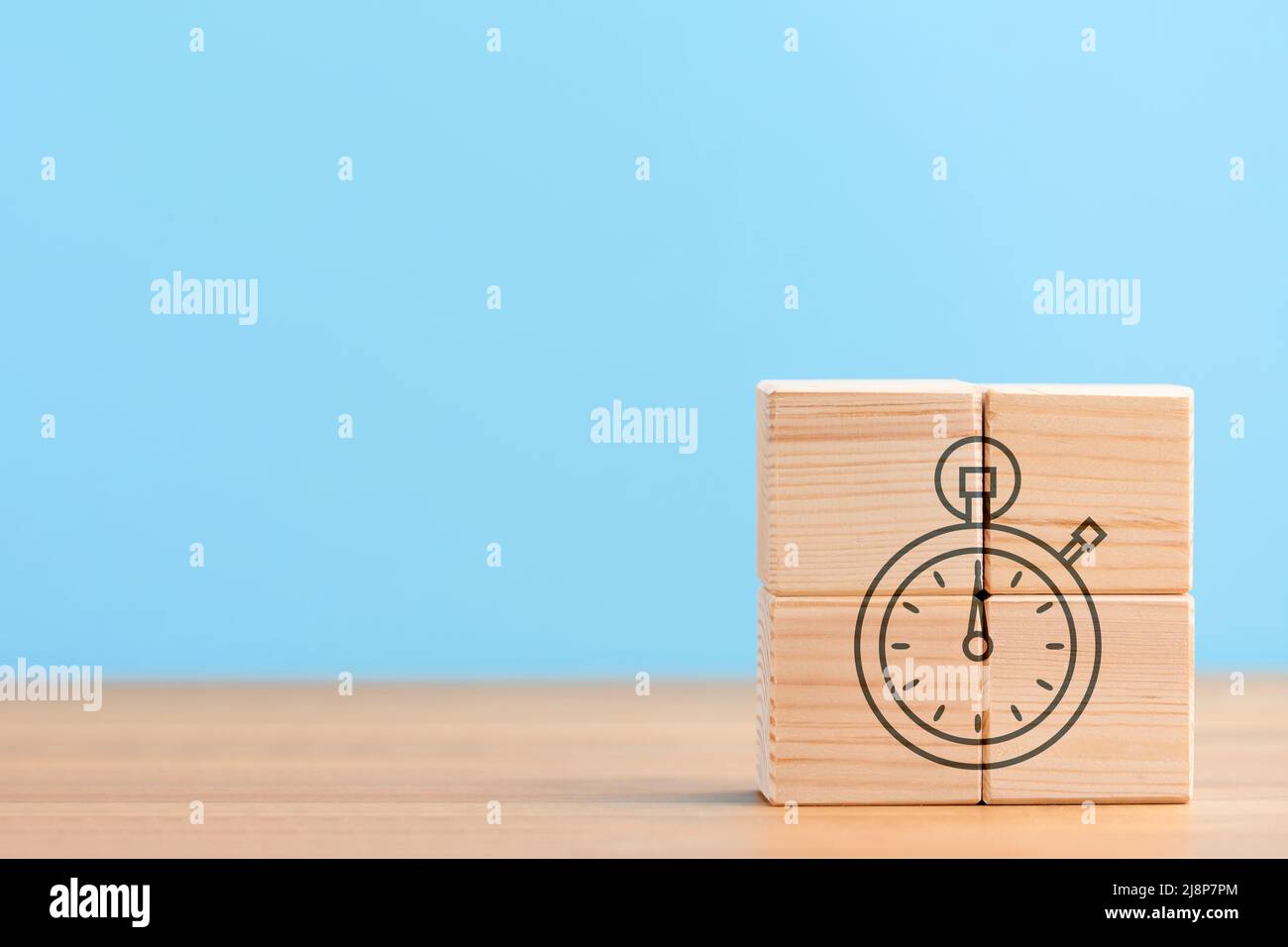 Wooden cubes on blue background with icon of time management stopwatch ...