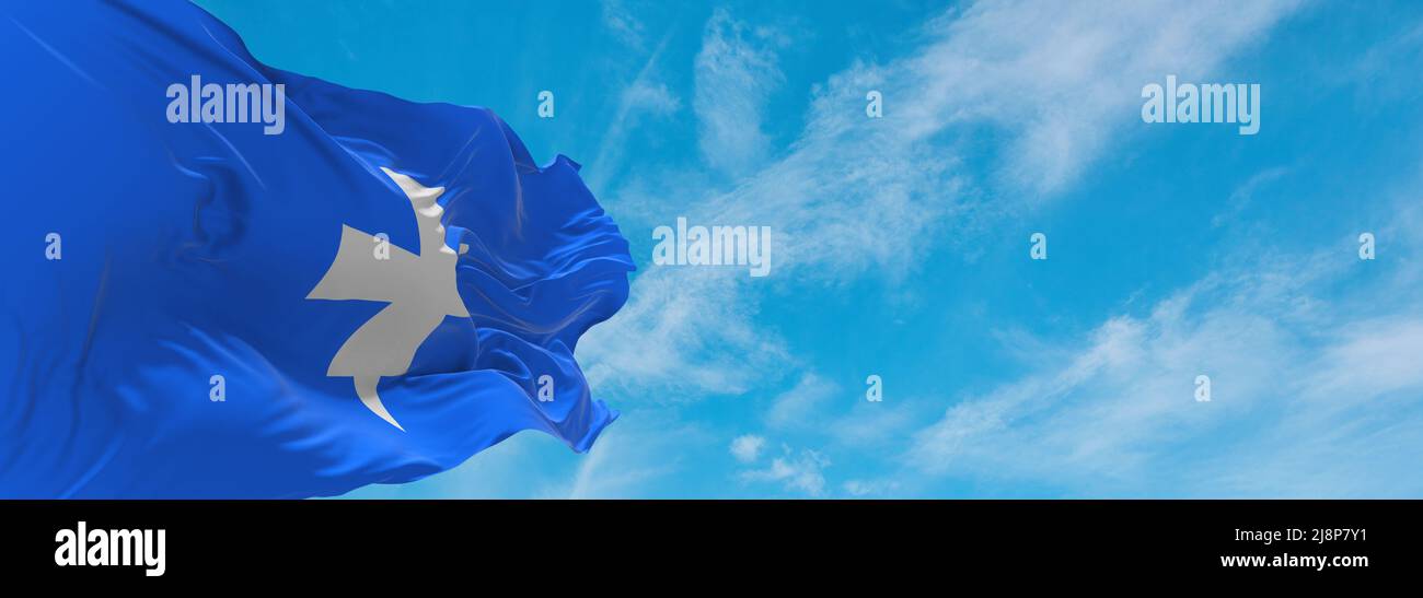 official flag of Rogaland , Norway at cloudy sky background on sunset ...