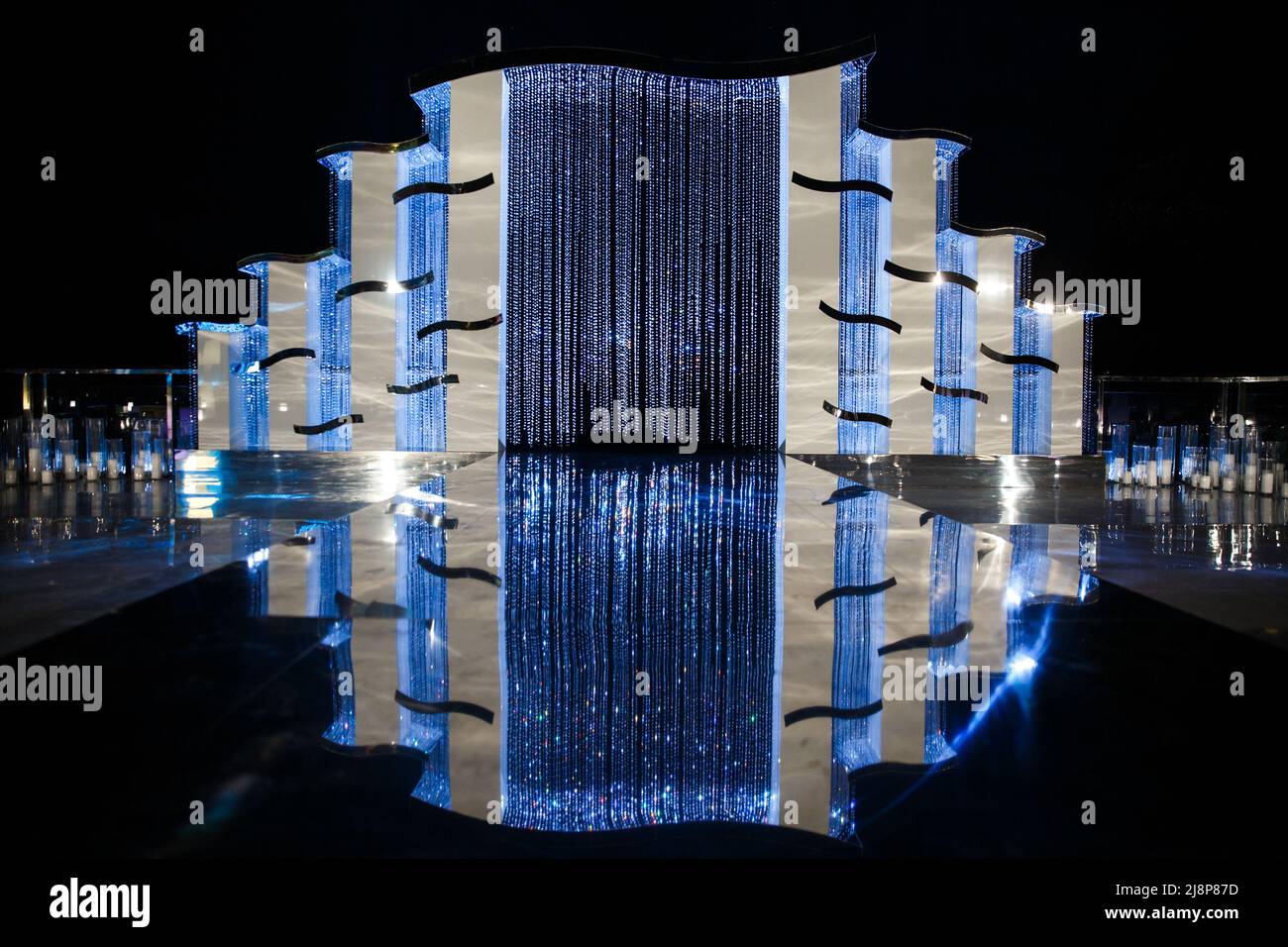 The arch for the wedding ceremony glows at night Stock Photo - Alamy