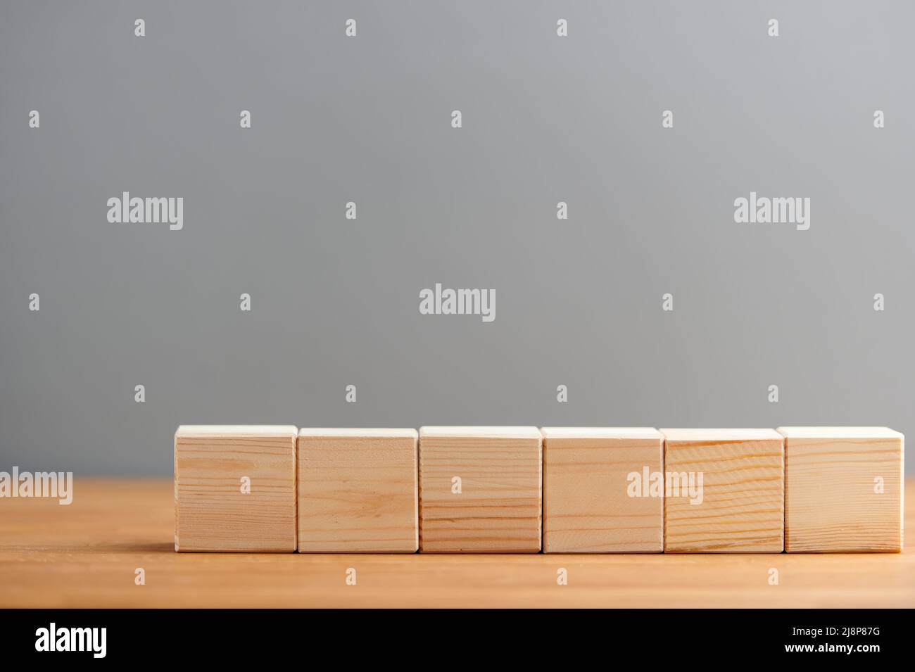 Blank wooden block cubes on a gray background for your text and advertisement. Free space for ...