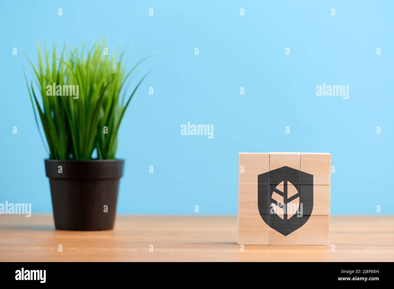 Ecology concept, wooden blocks with icon of nature eco shield green ...