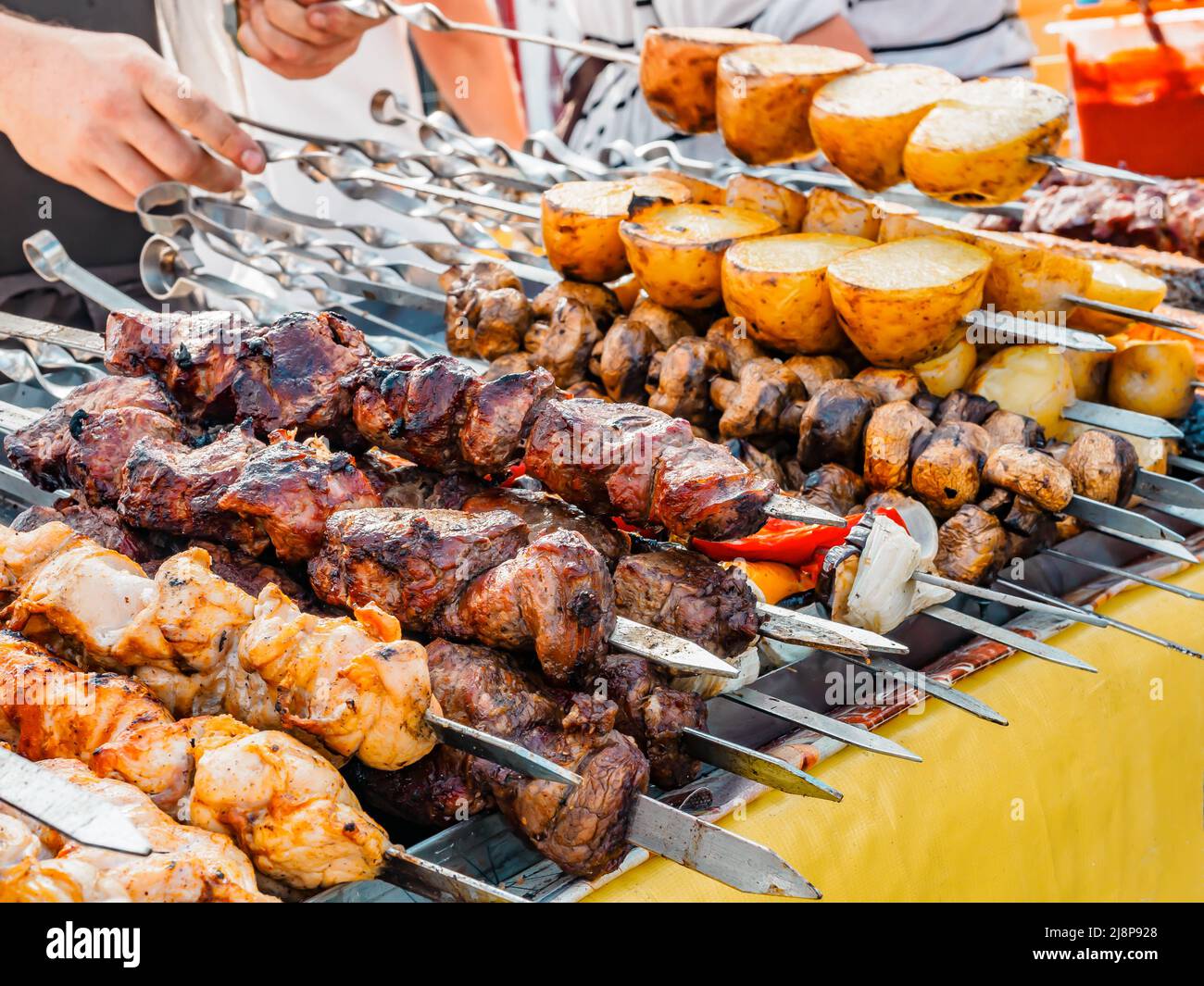 Cooking shashlik on a metal skewer and grilled vegetables. Grilled meat ...