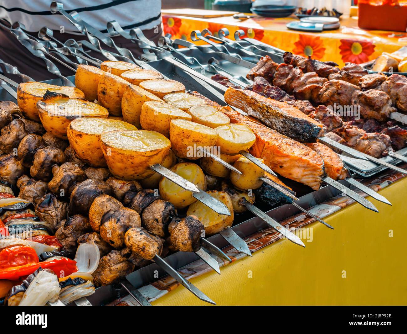 Cooking shashlik on a metal skewer and grilled vegetables. Grilled meat ...