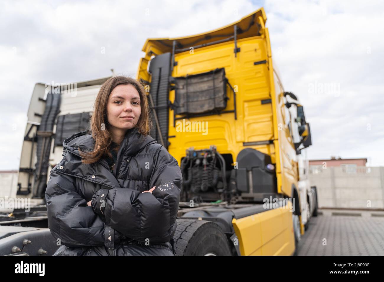 Caucasian young woman driving truck. trucker female worker, transport ...