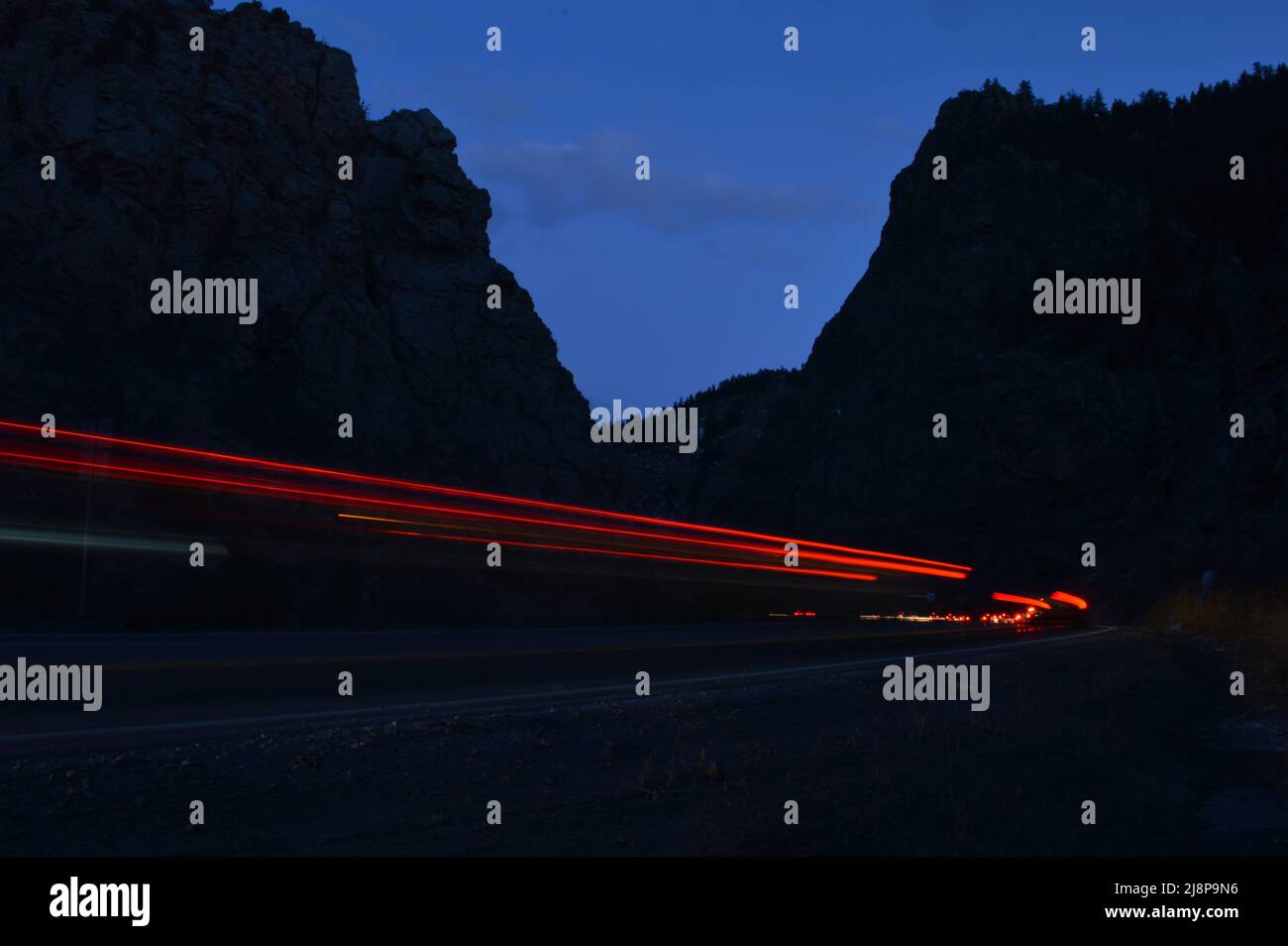 Traffic streaking through mountain canyon Stock Photo - Alamy