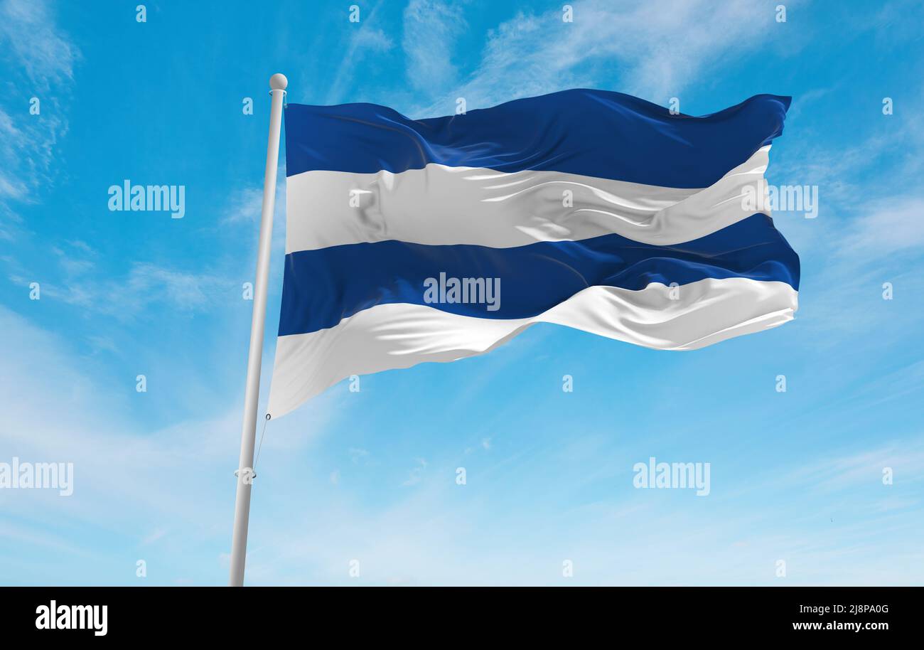 official flag of Oslo 1924 , Norway at cloudy sky background on sunset ...