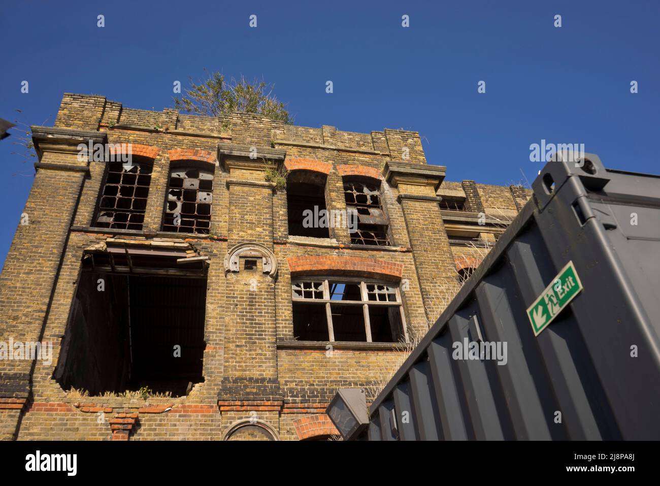 Old building being redeveloped under railway arches by train and ...