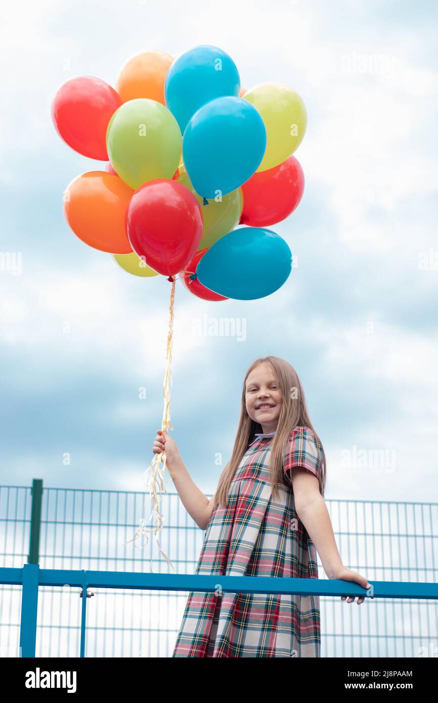 Teenage girl with colorful helium air balloons having fun outdoors ...