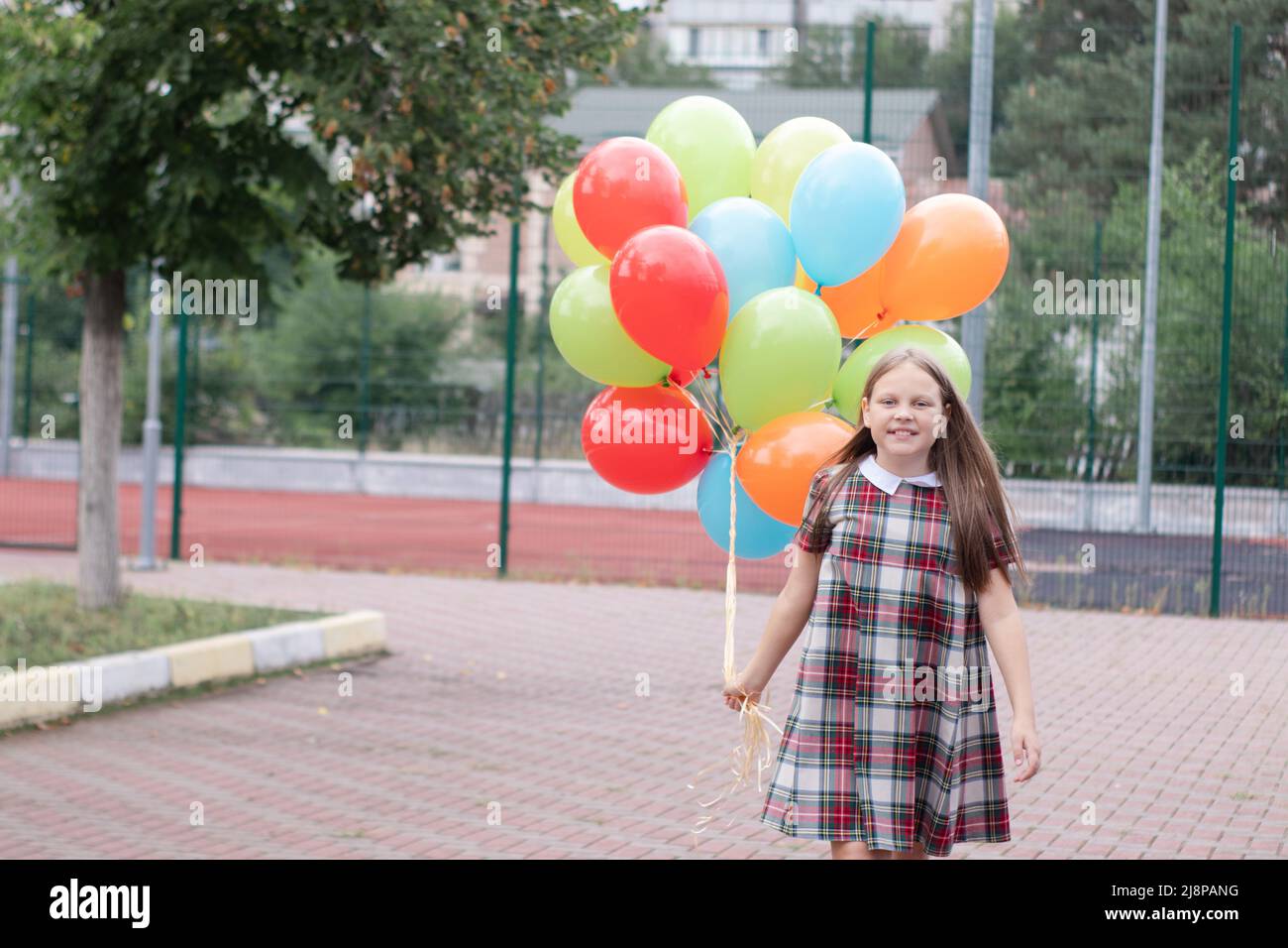 Teenage girl with colorful helium air balloons having fun outdoors ...