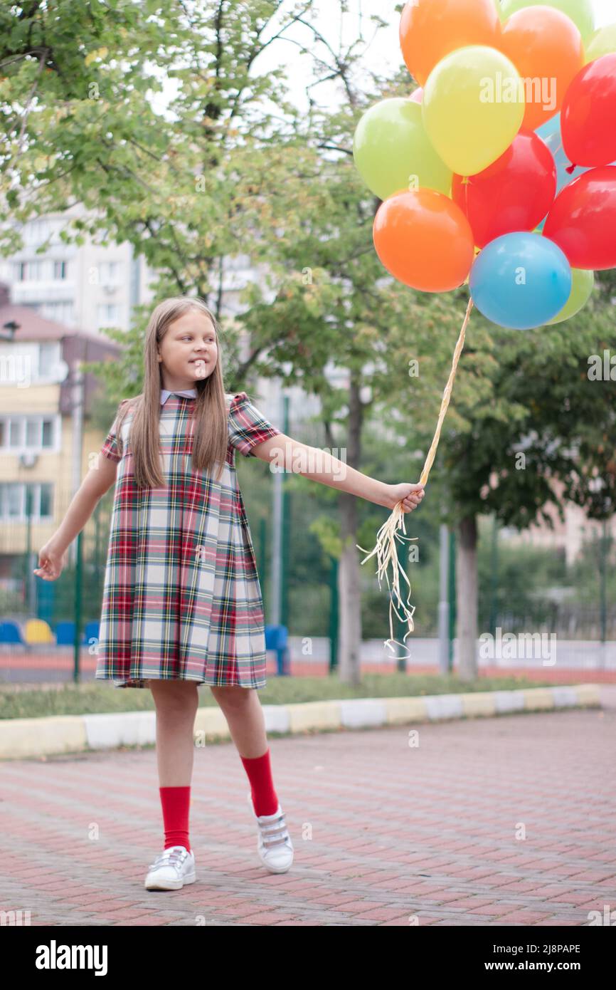 Teenage girl with colorful helium air balloons having fun outdoors ...