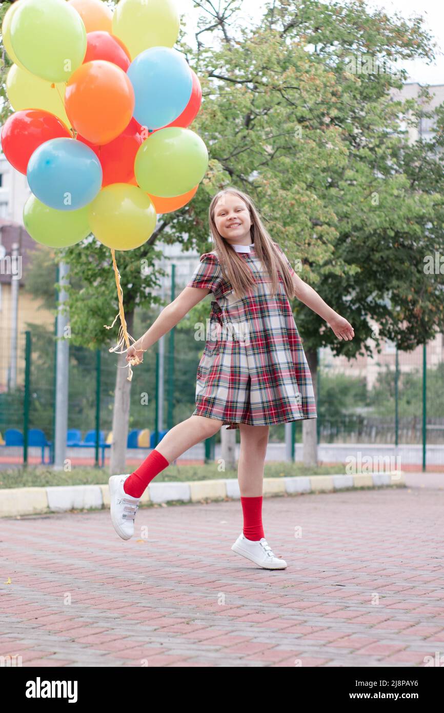 Teenage girl with colorful helium air balloons having fun outdoors ...