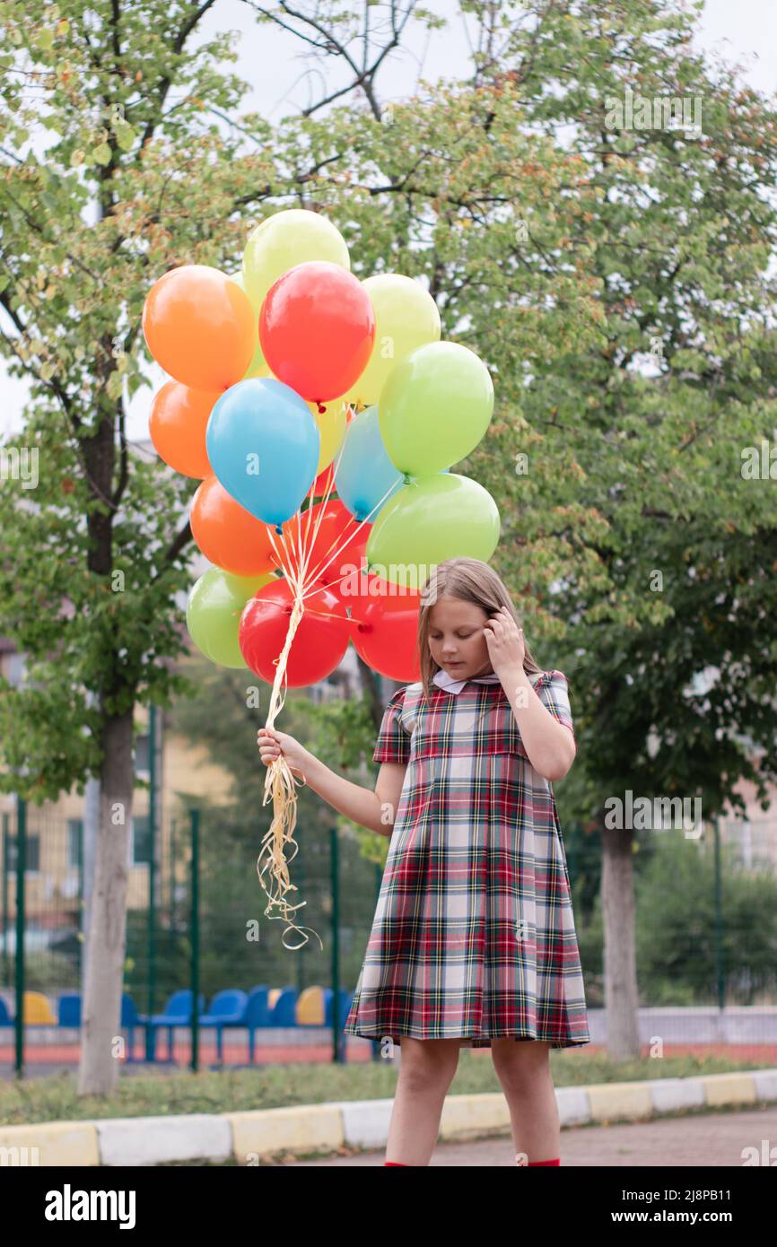 Teenage girl with colorful helium air balloons having fun outdoors ...
