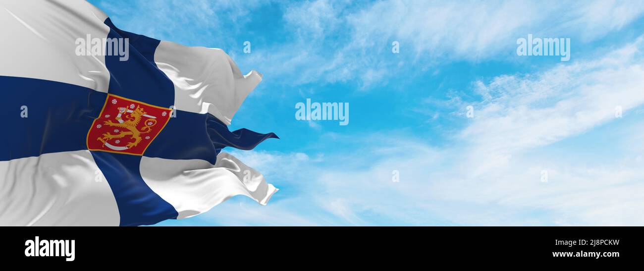 official flag of Military , Finland at cloudy sky background on sunset ...