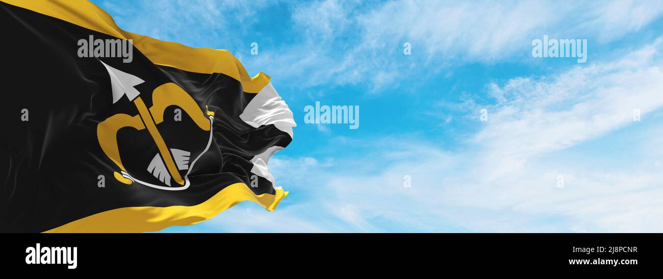 official flag of Northern Savonia , Finland at cloudy sky background on ...