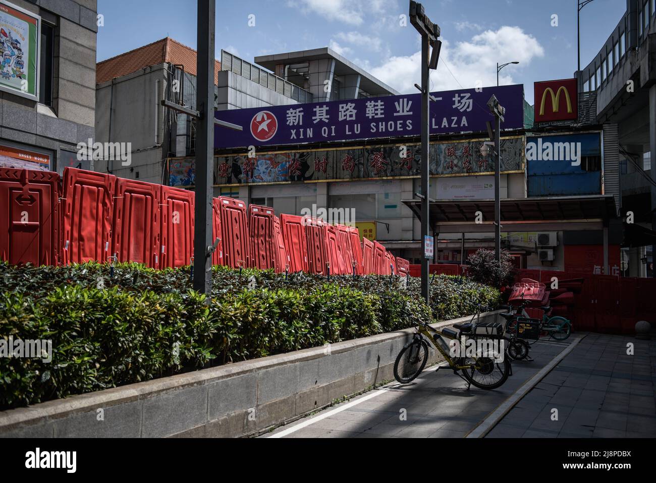 GUANGZHOU, CHINA - MAY 17, 2022 - Citizens walk past a gated community ...