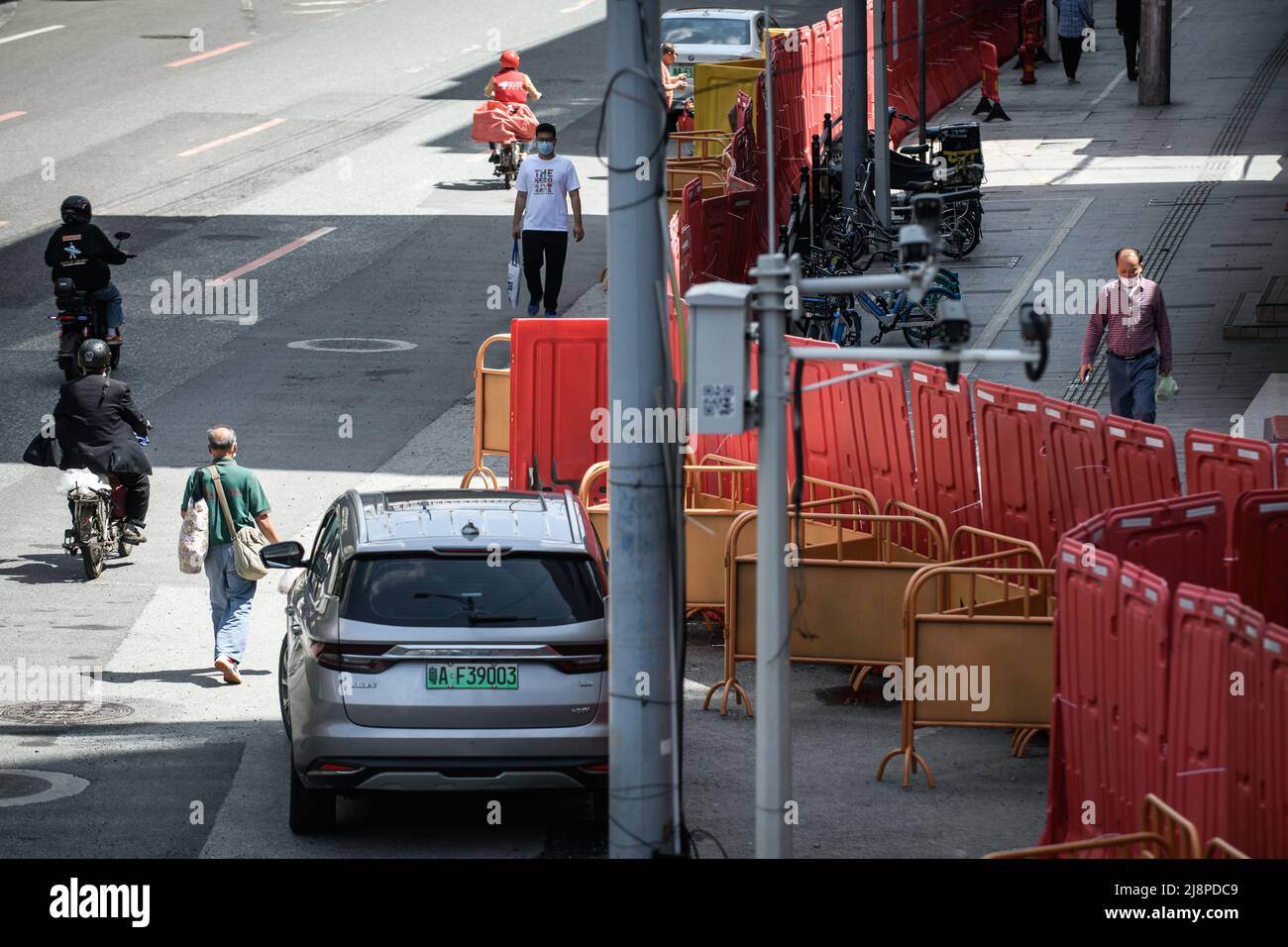 GUANGZHOU, CHINA - MAY 17, 2022 - A citizen walks past a gated ...