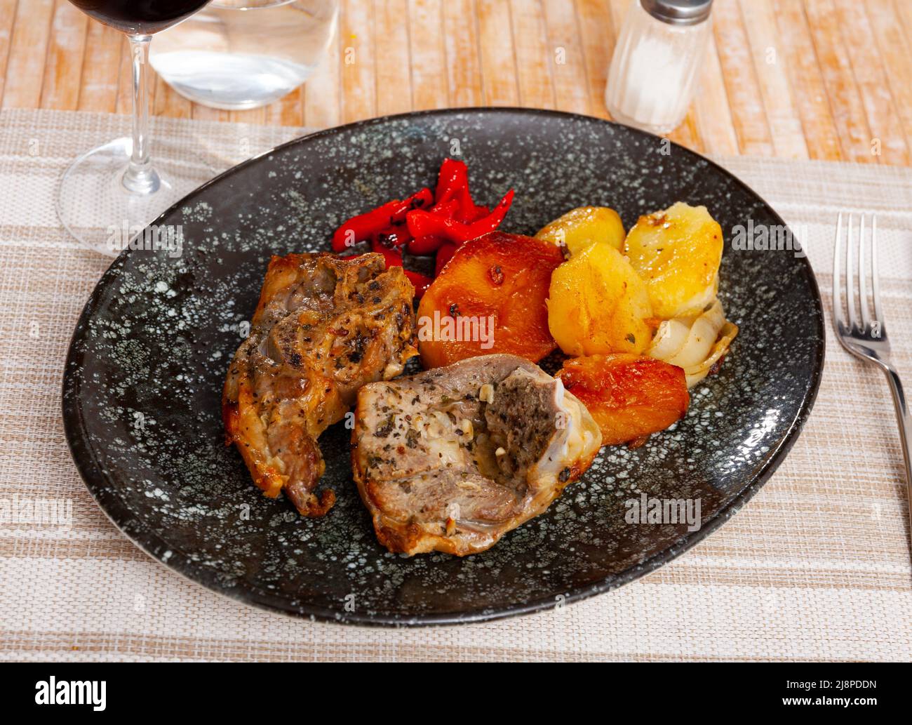 Dish of lamb leg with potatoes and pepper Stock Photo - Alamy