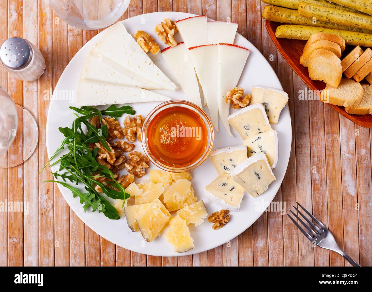 Various types of cheese on white plate Stock Photo - Alamy