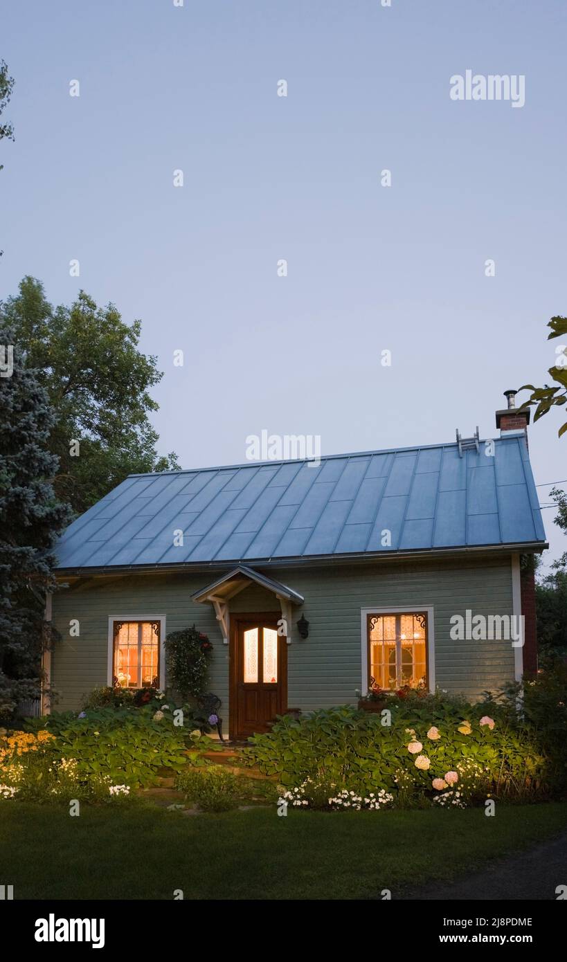 Old circa 1900 Canadiana cottage style home with olive green wood plank ...