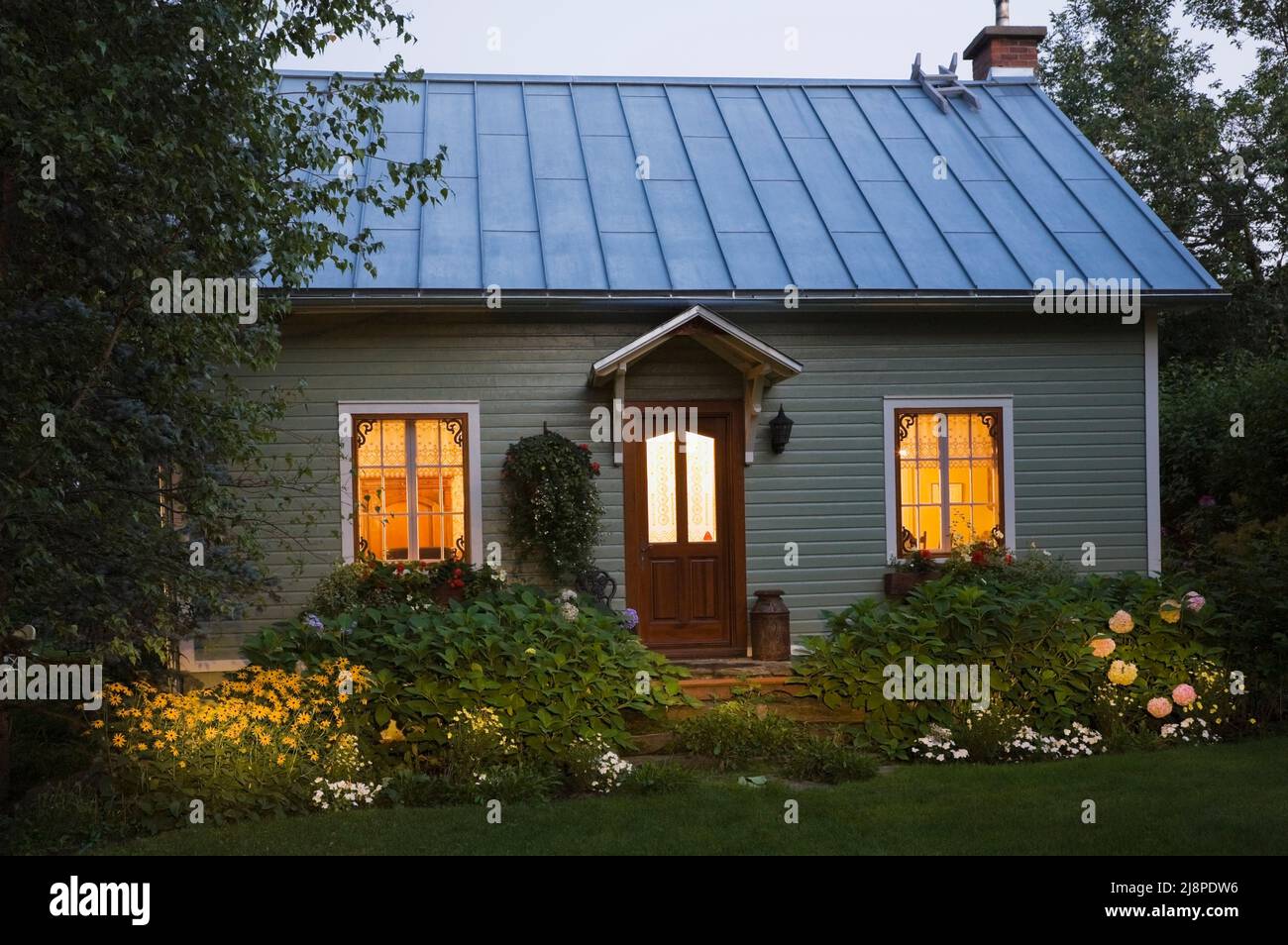 Old circa 1900 Canadiana cottage style home with olive green wood plank ...