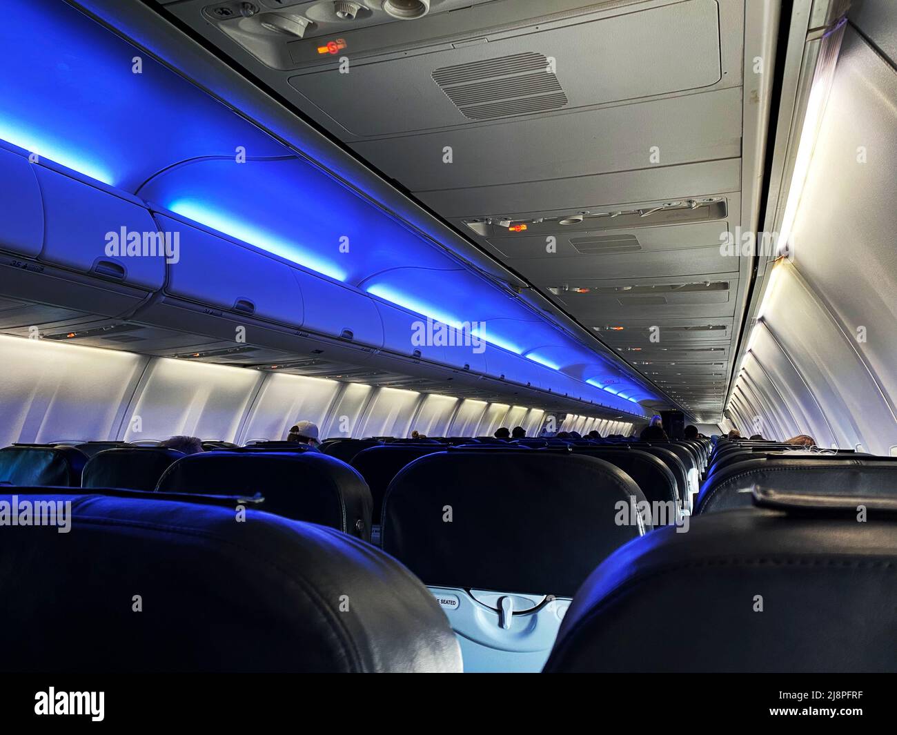A nearly empty airplane, seen from the rear Stock Photo - Alamy