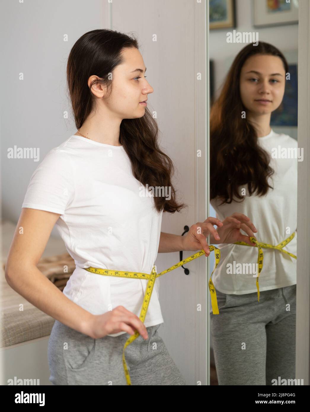 Young woman taking body measurements hi-res stock photography and ...