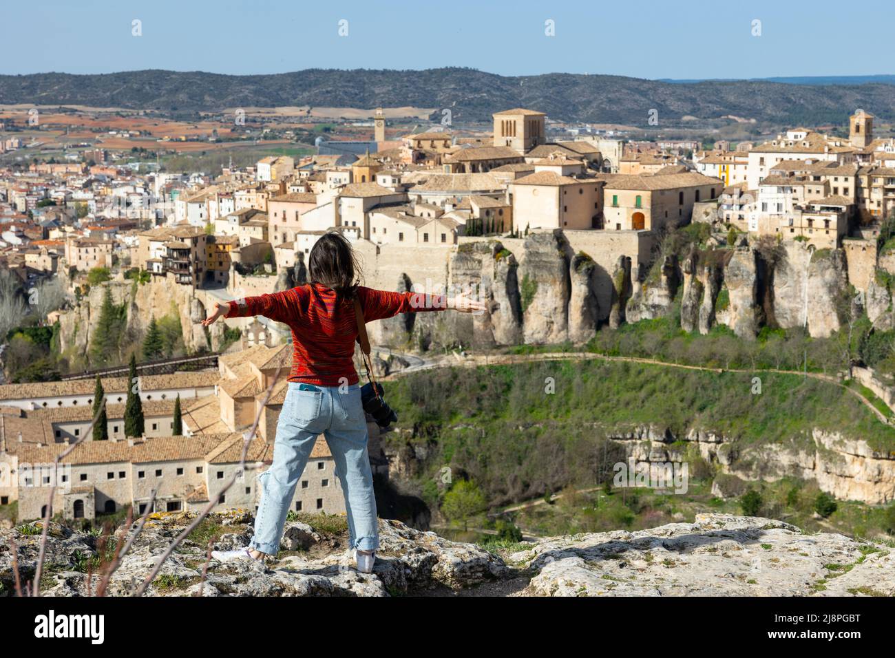 Woman tourist with a camera, against the background of the city of ...