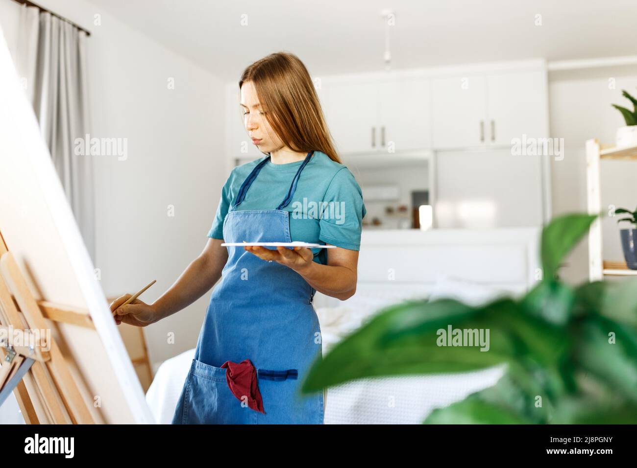Woman artist holding paintbrush.Creative woman enjoying painting.Young ...