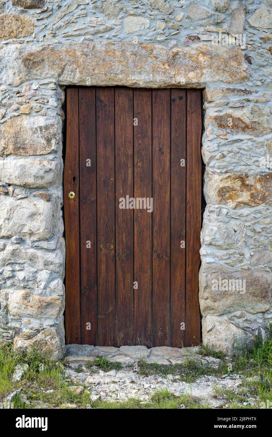 Ancient wooden door in stone wall Stock Photo - Alamy