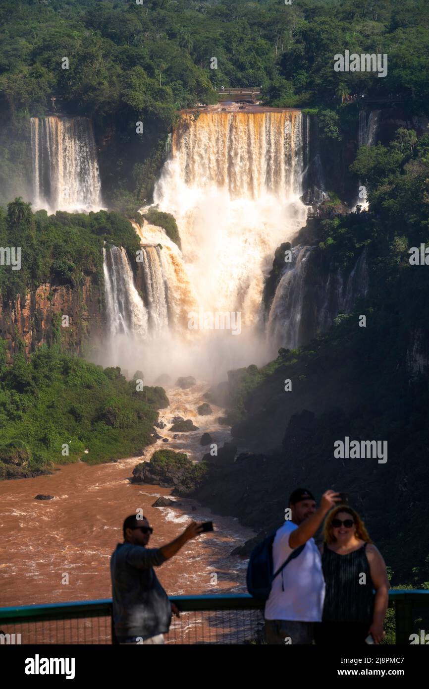 Tourists admiring the Iguazu Falls, one of the biggest falls in the ...